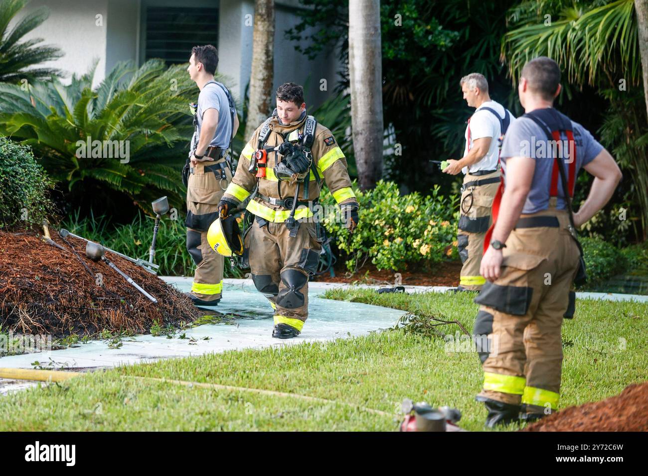Tampa firefighters work to contain a house fire after Hurricane Helene ...