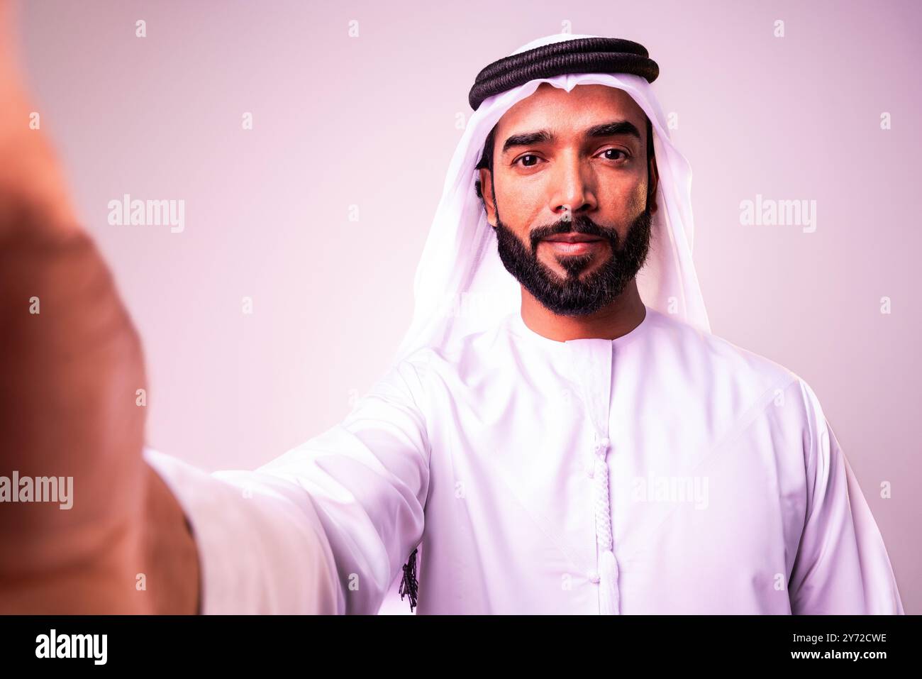 Arab businessman wearing emirati kandura portrait in studio in Dubai ...