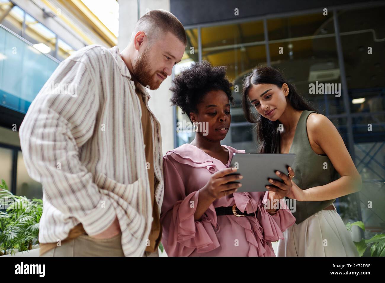 Medium shot of three business people from different ethnic backgrounds ...