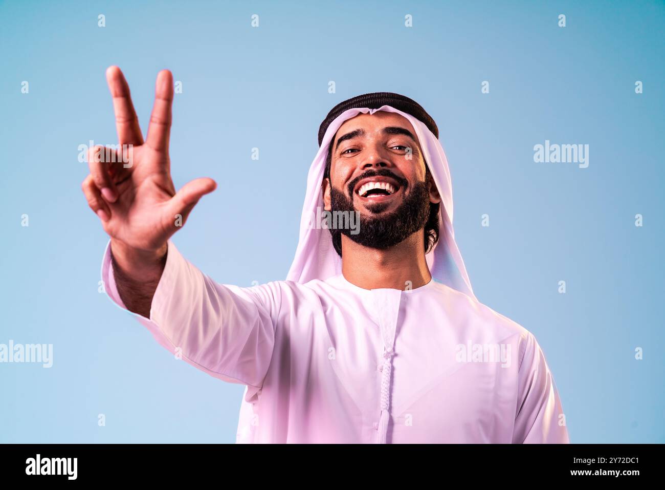 Arab businessman wearing emirati kandura portrait in studio in Dubai ...