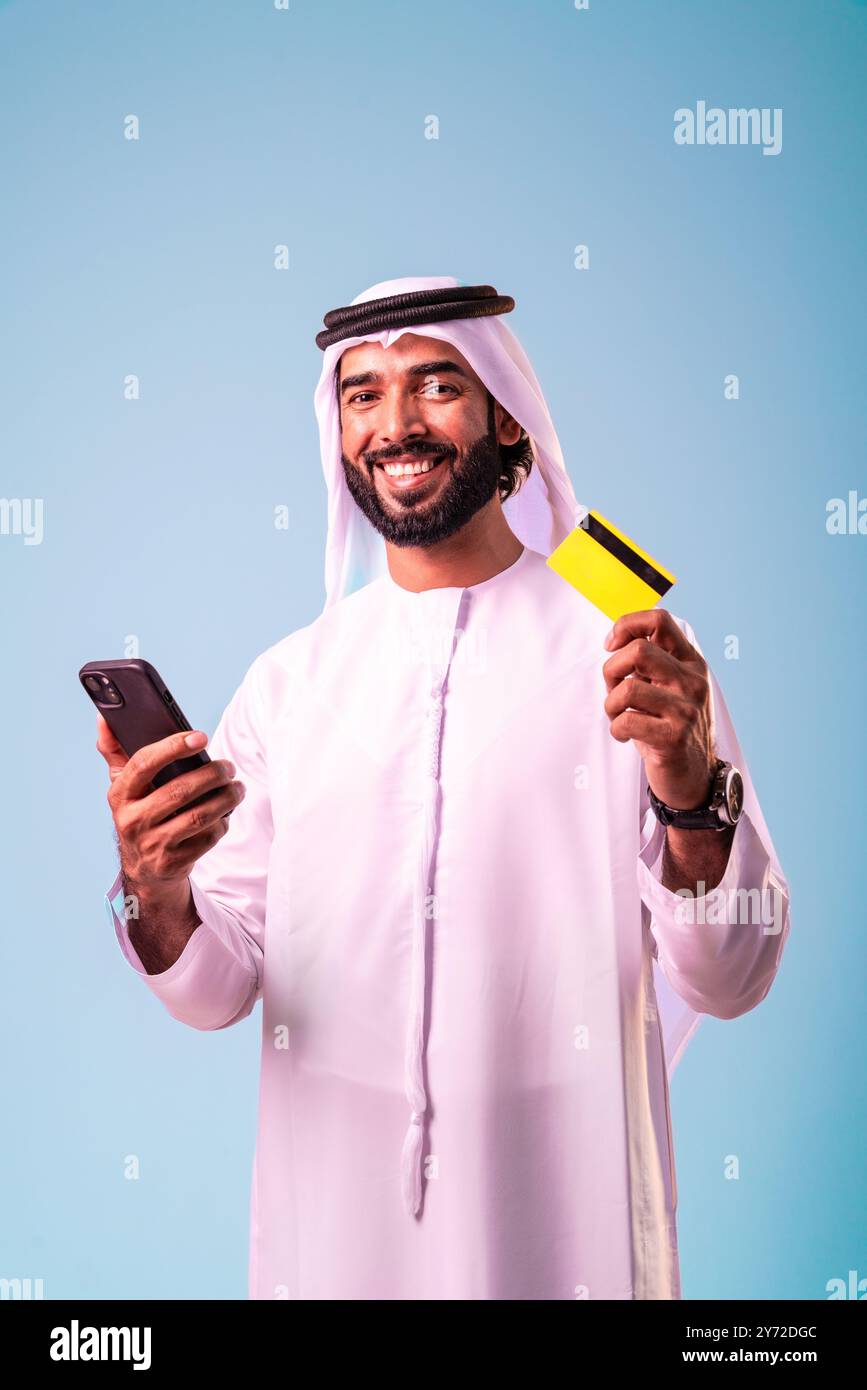 Arab businessman wearing emirati kandura portrait in studio in Dubai ...