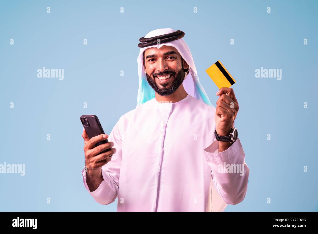 Arab businessman wearing emirati kandura portrait in studio in Dubai ...