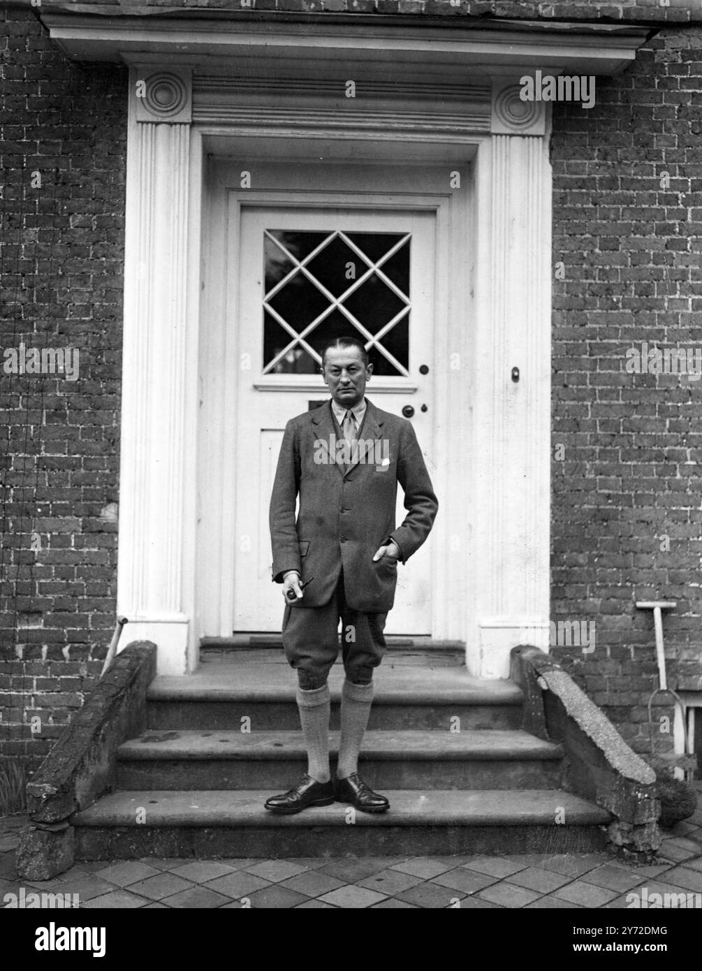Sir Humphrey de Trafford on the steps of the front porch as he poses ...
