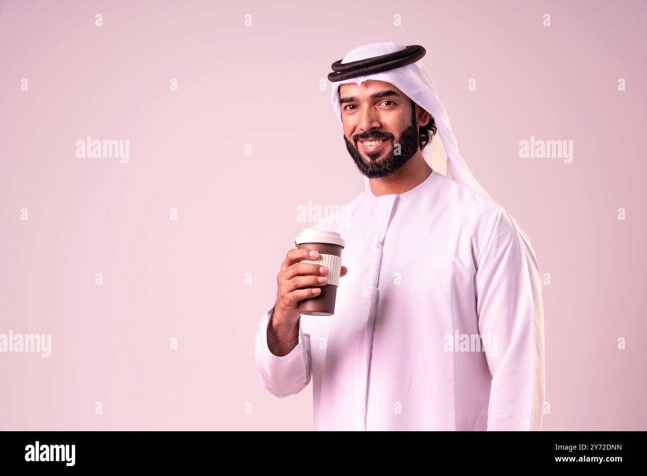 Arab businessman wearing emirati kandura portrait in studio in Dubai - Handsome middle eastern ...