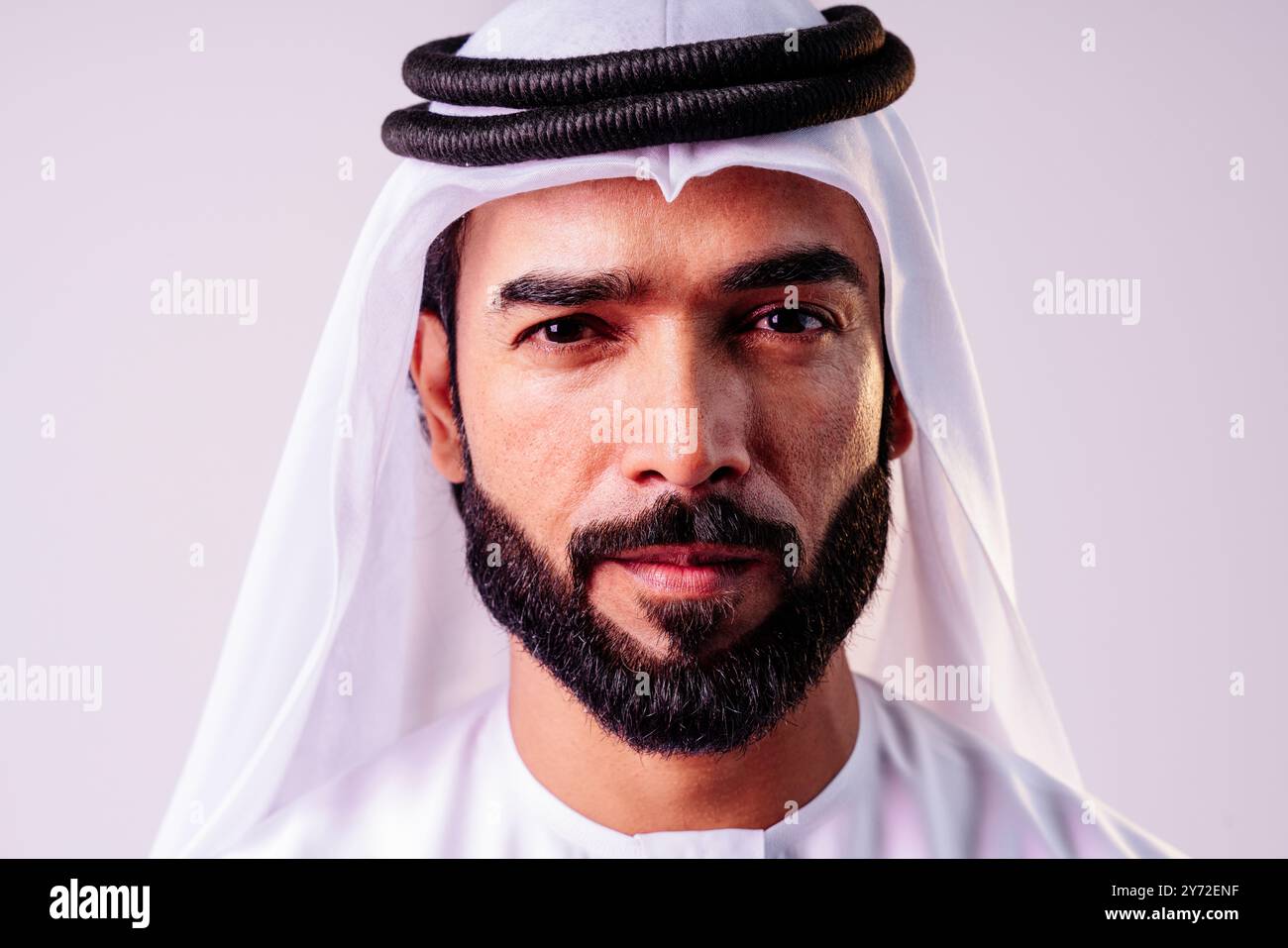 Arab businessman wearing emirati kandura portrait in studio in Dubai ...