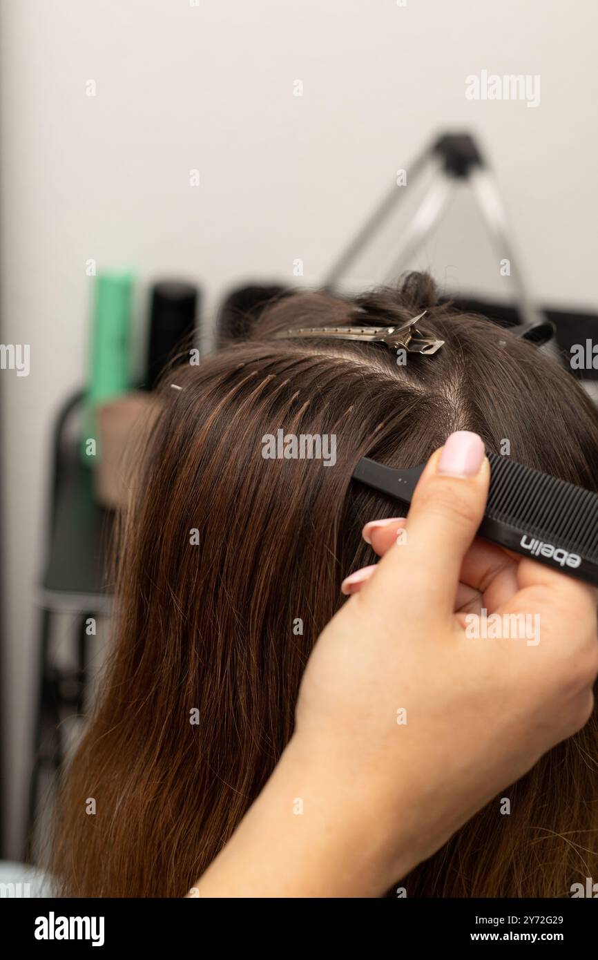 The process of hair extensions. Hair encapsulation. Beauty parlour ...