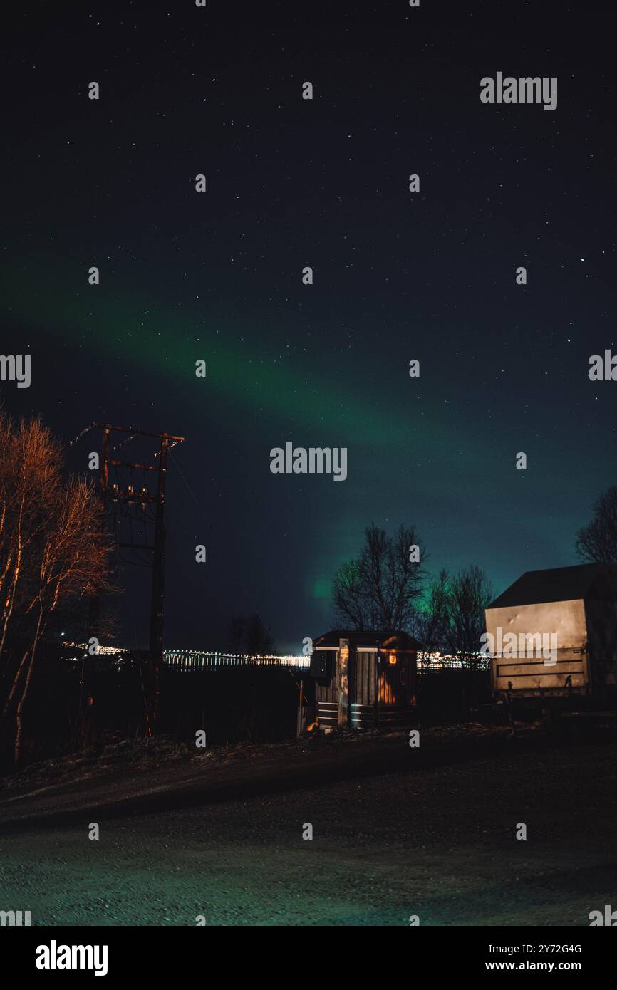 Northern lights over Norwegian arctic countryside at night in autumn ...