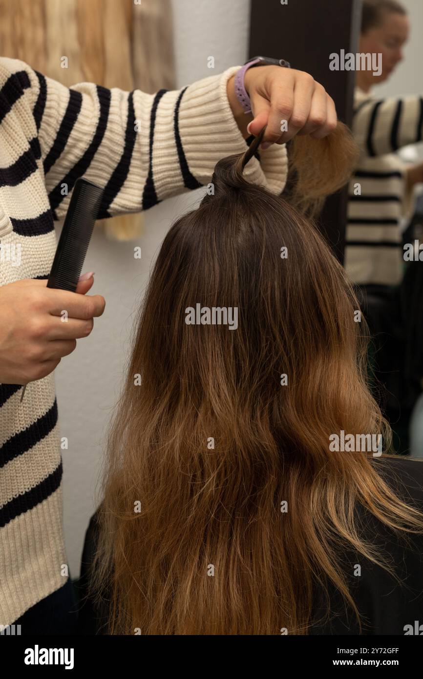 The process of hair extensions. Hair encapsulation. Beauty parlour ...