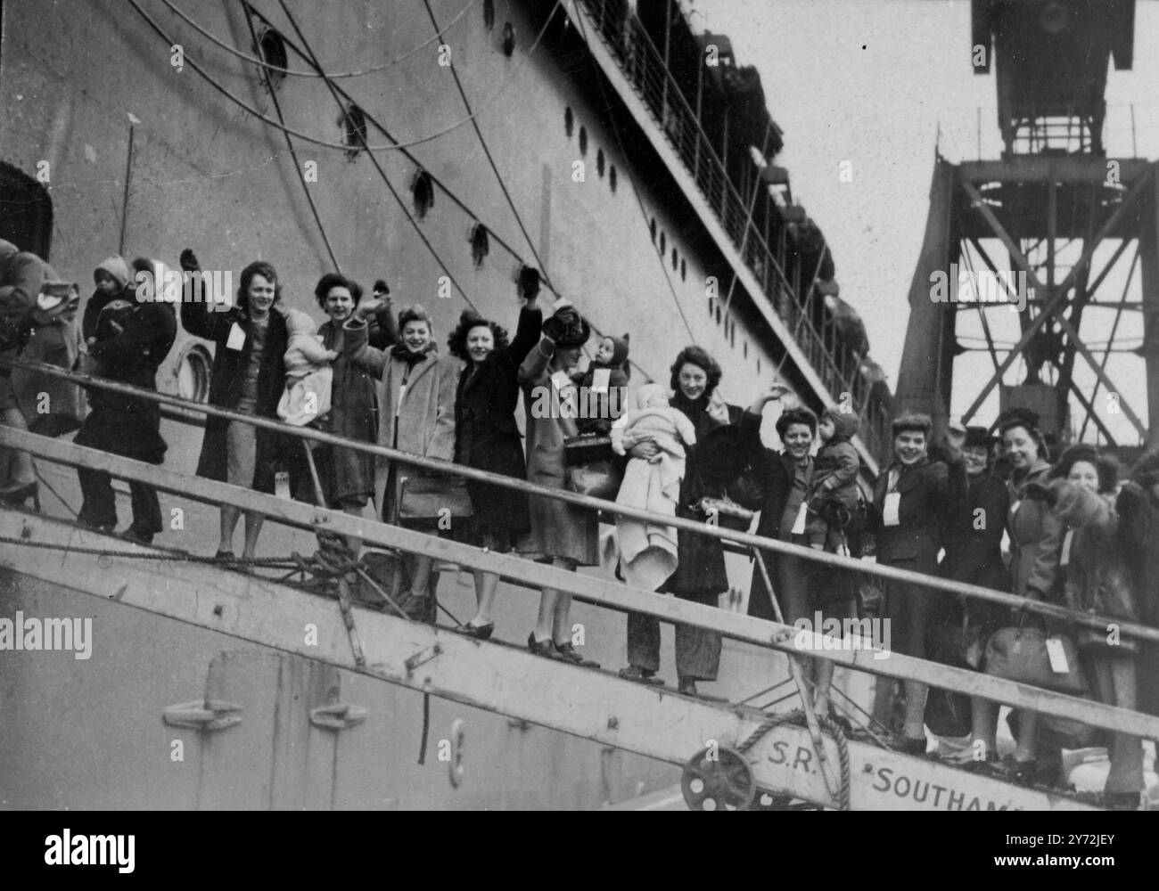 Women and children going aboard an unknown ship in Southampton Stock ...