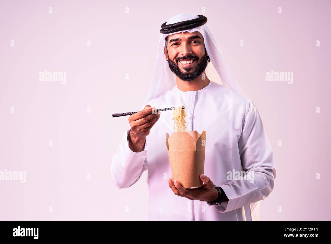 Arab businessman wearing emirati kandura portrait in studio in Dubai ...