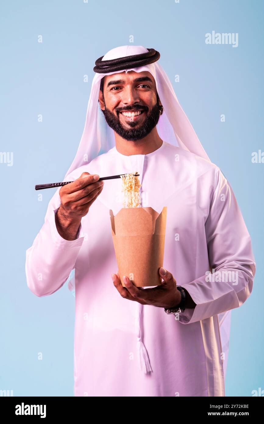 Arab businessman wearing emirati kandura portrait in studio in Dubai ...