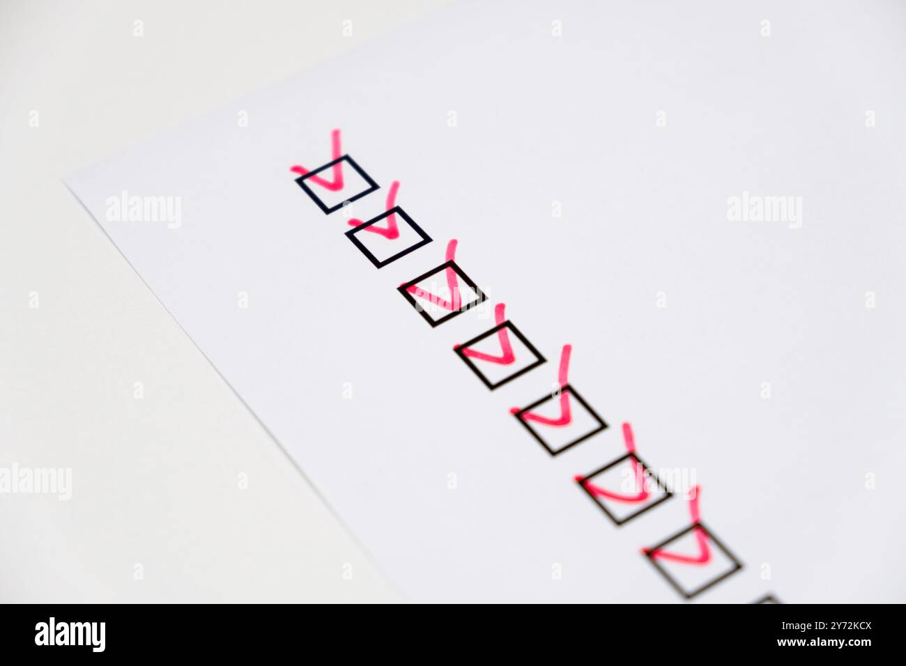 checkboxes with red marking on checklist on white paper Stock Photo - Alamy