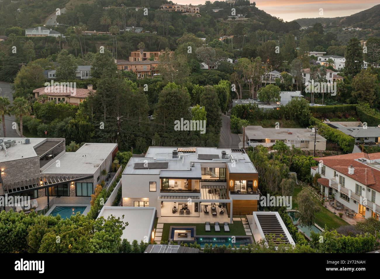 Aerial view of luxurious houses in a lush, green neighborhood with a ...