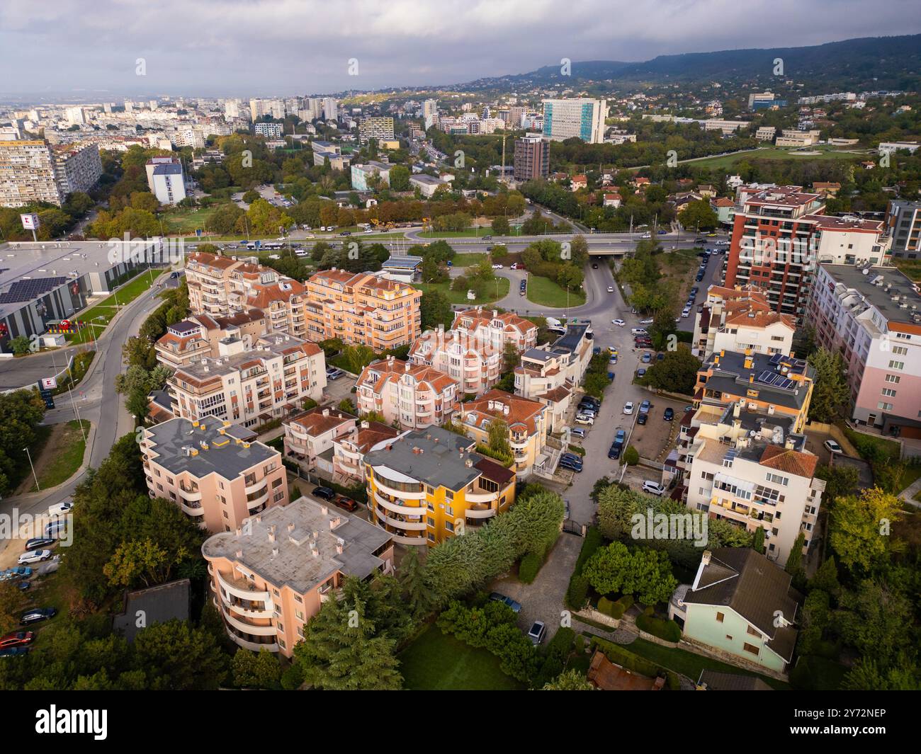 Aerial view of a suburban area with modern apartment buildings, green ...