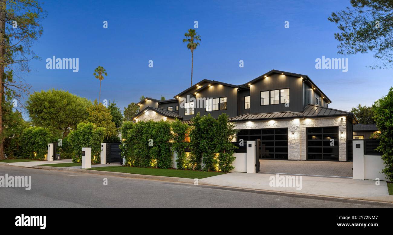 Modern luxury home with well-maintained garden and driveway under a ...