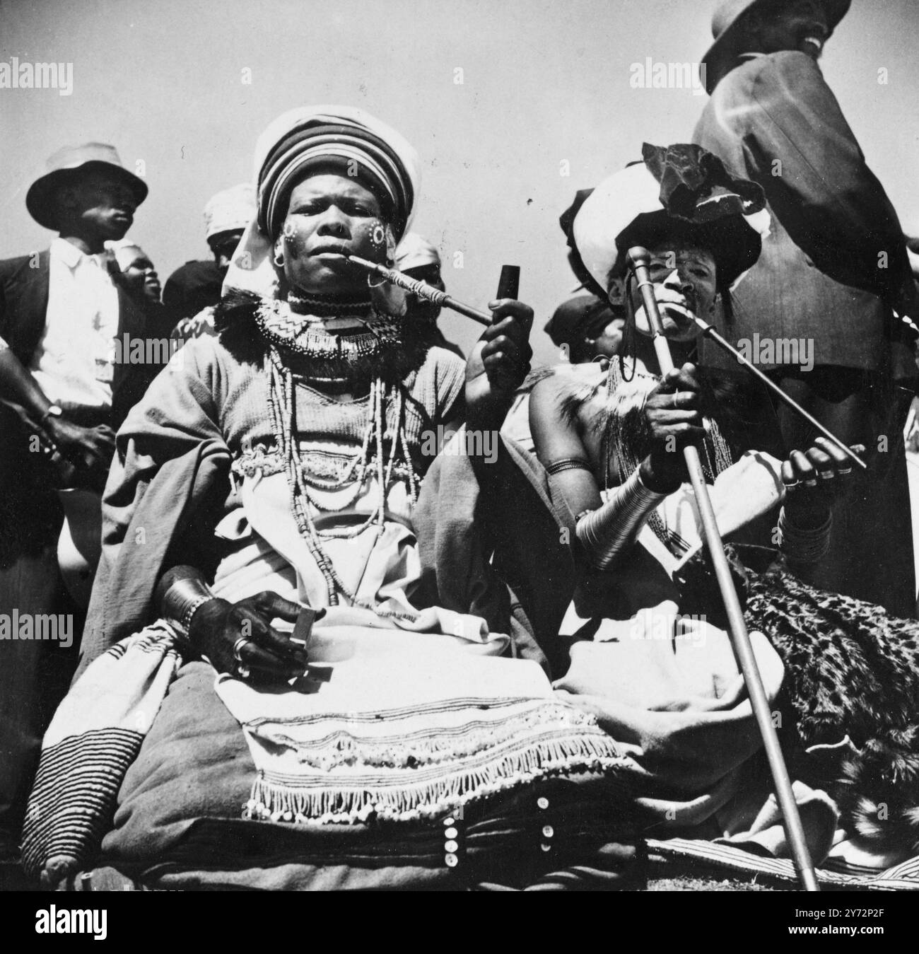 Ladies, you may smoke. Two colourful native women smoking long wooden ...