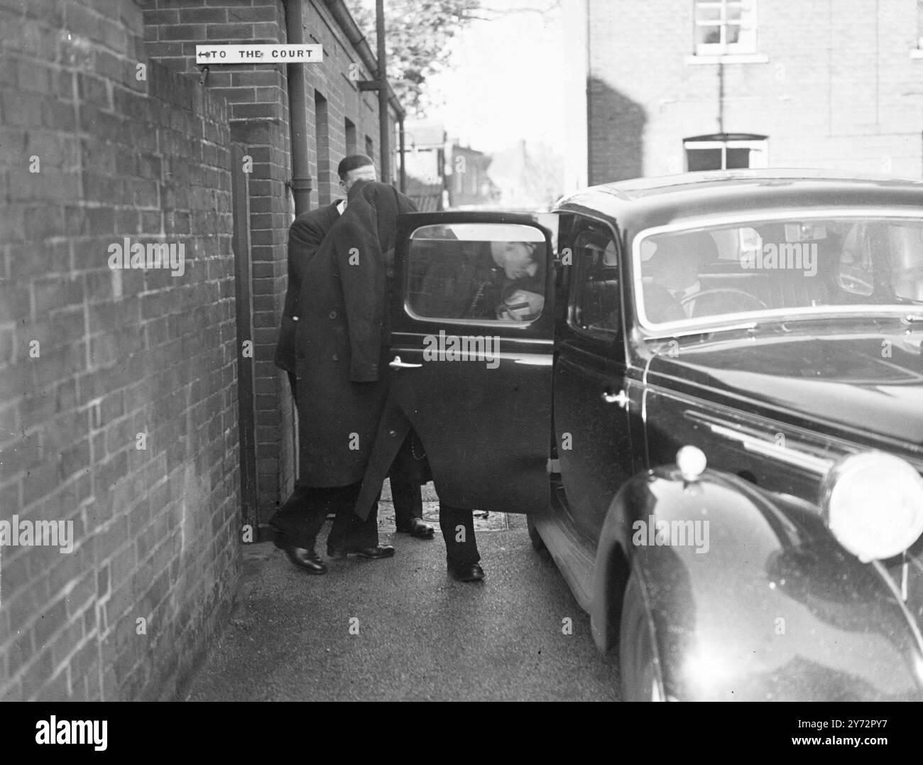 Dorset murder trial. The accused, with black cloth over his head, is ...