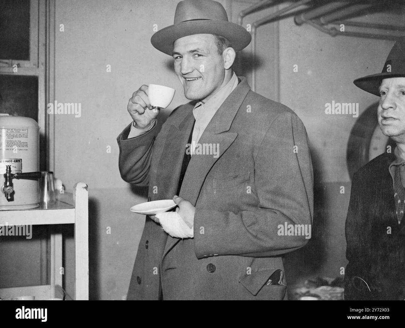 The American heavyweight Joe Baksi enjoys a cup of tea immediately ...