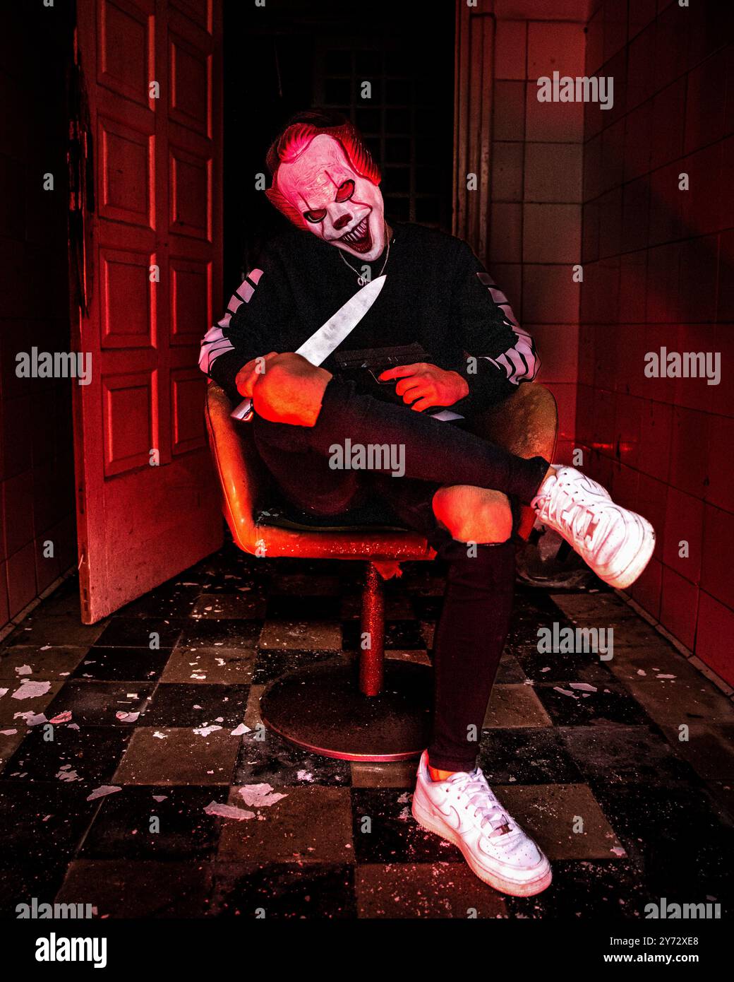 The killer clown. A mysterious masked character in a gloomy abandoned ...