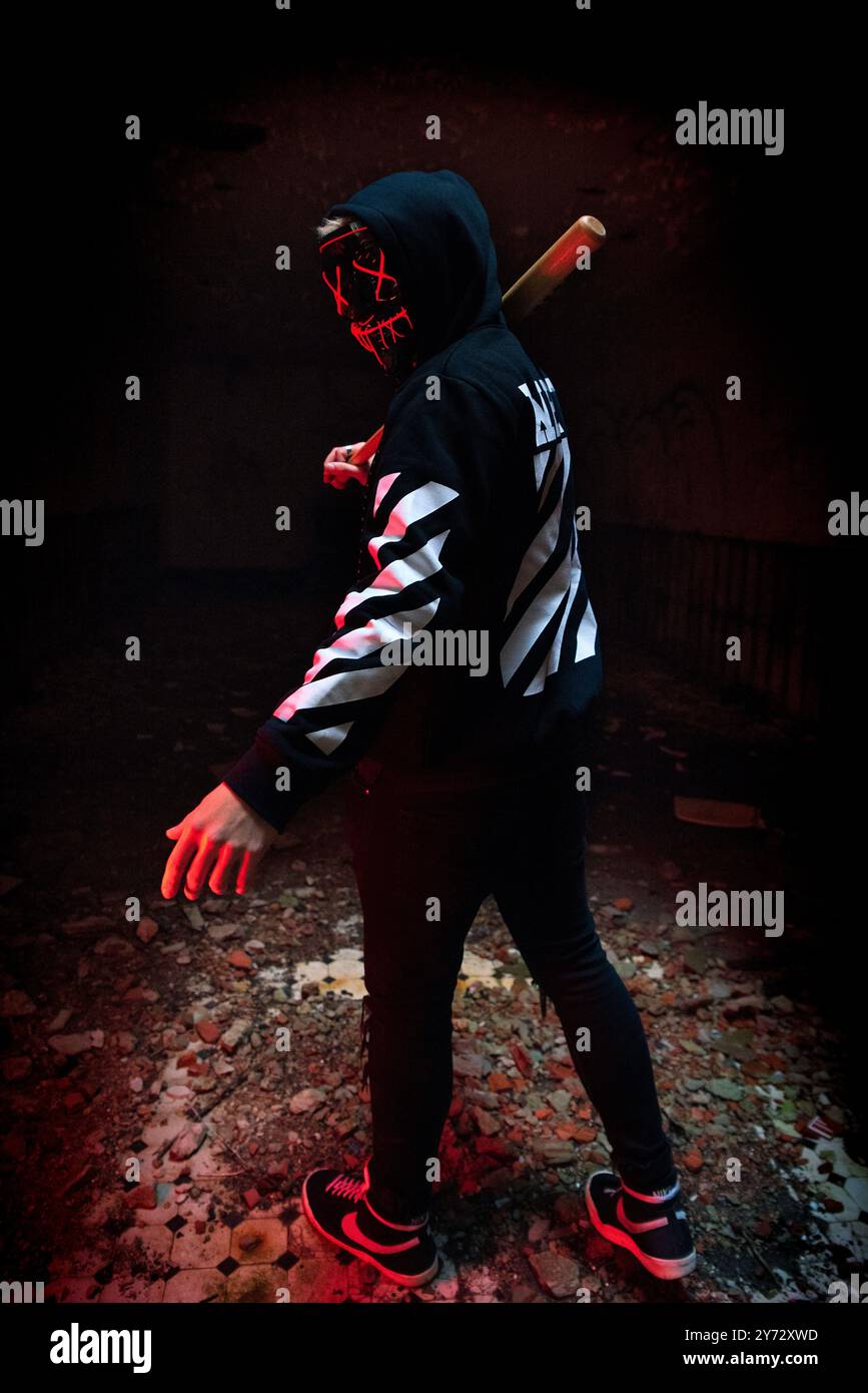 A creepy masked character of the purge anarchy with a baseball bat ...