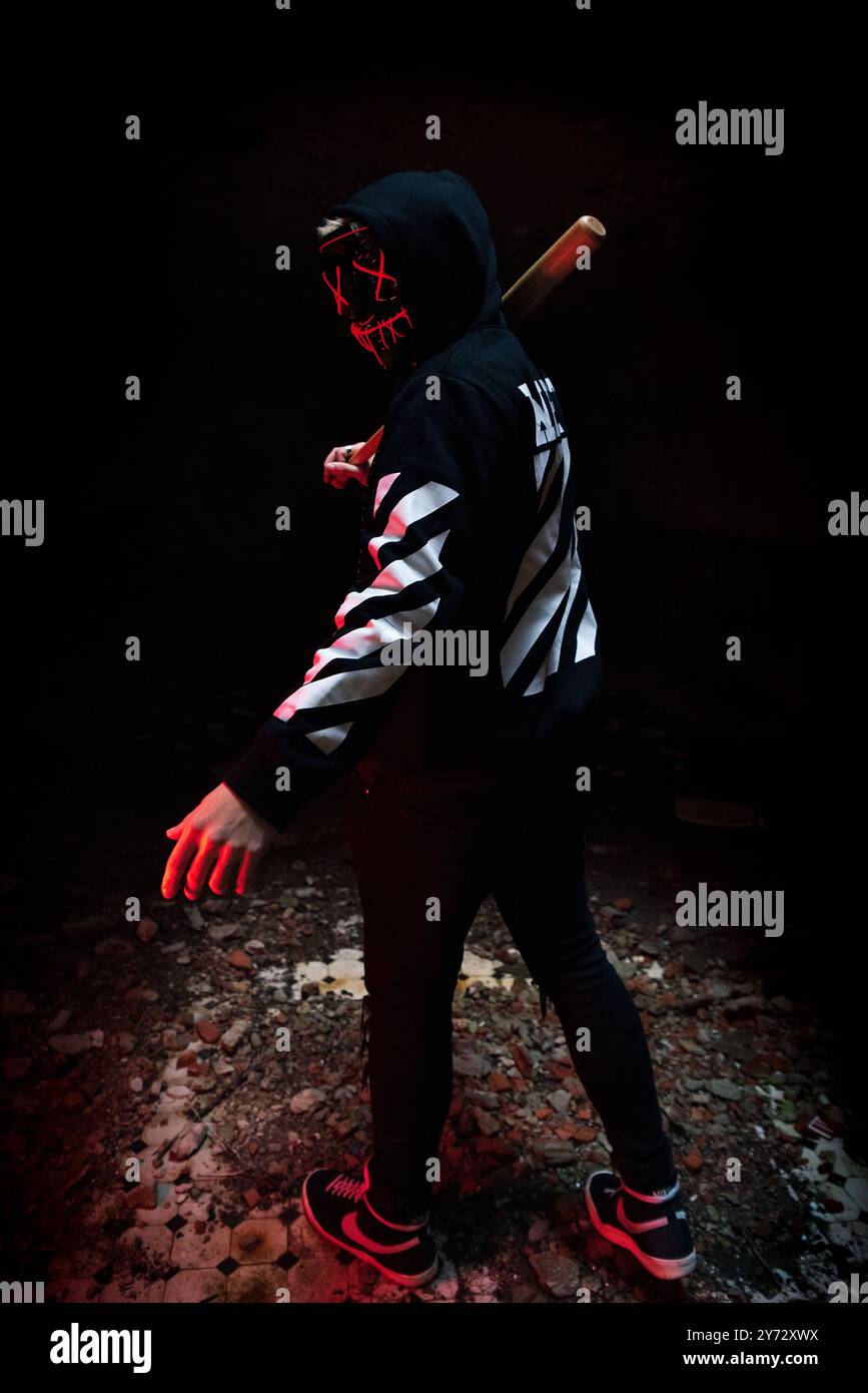 A creepy masked character of the purge anarchy with a baseball bat ...