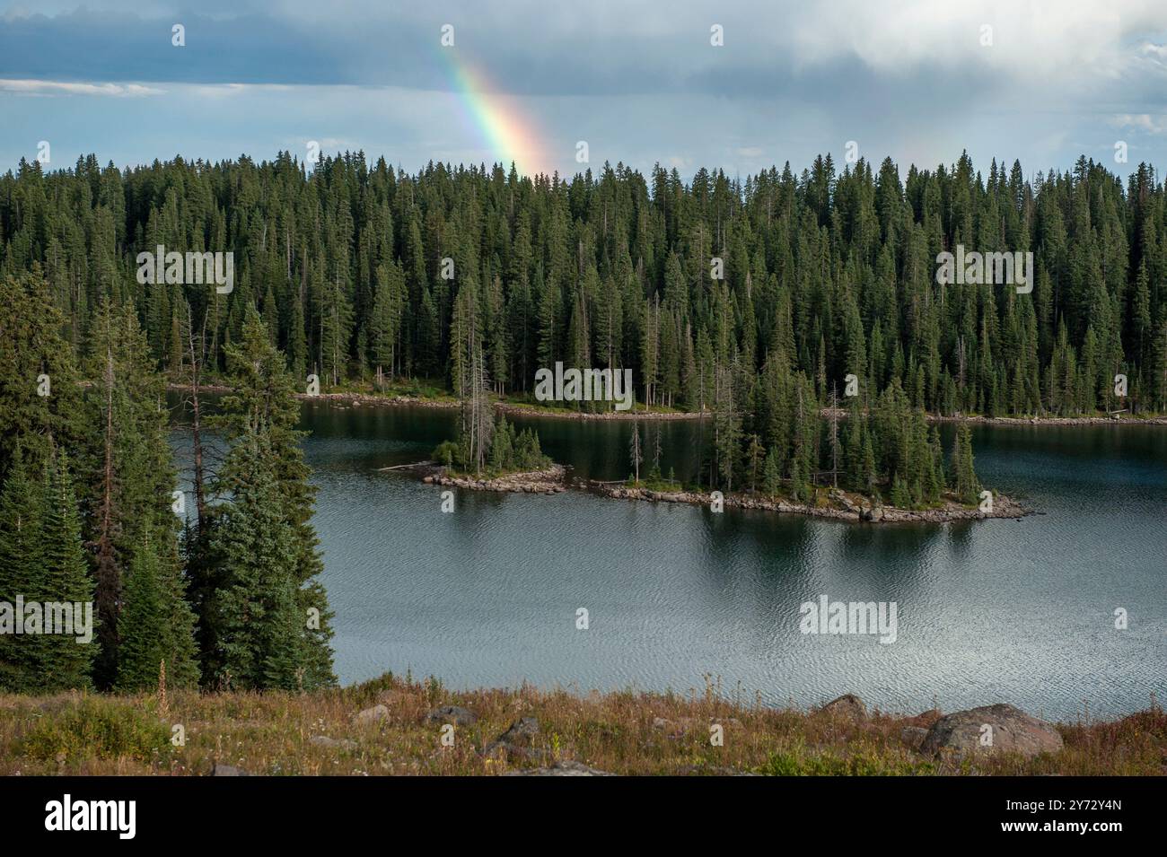 Island Lake on Colorado's Grand Mesa with a rainbow Stock Photo - Alamy