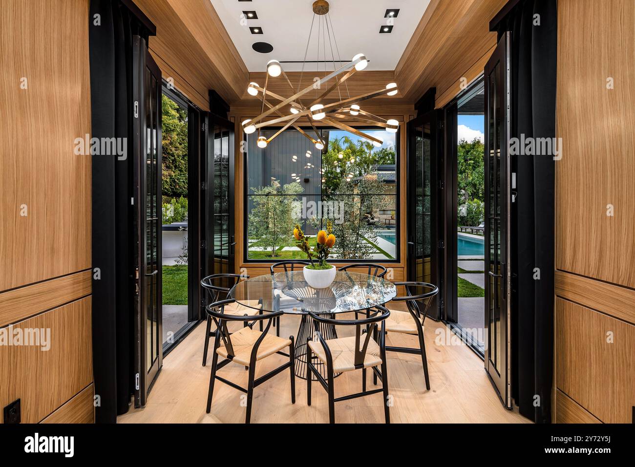 Modern dining area with glass table, elegant chairs, and a contemporary ...