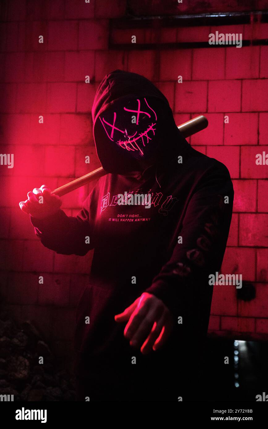 A creepy masked character of the purge anarchy with a baseball bat ...