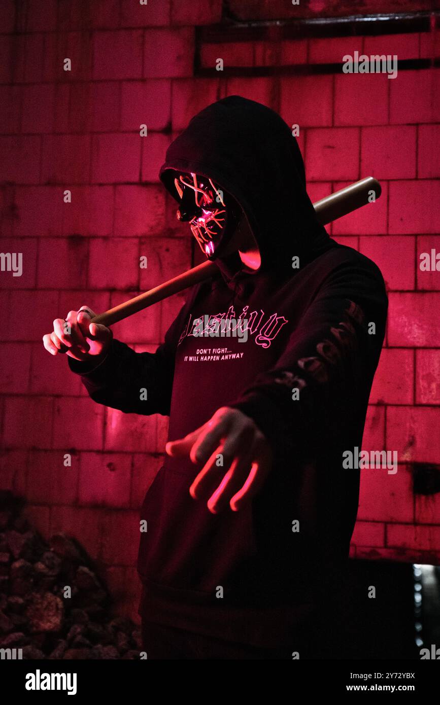 A creepy masked character of the purge anarchy with a baseball bat ...