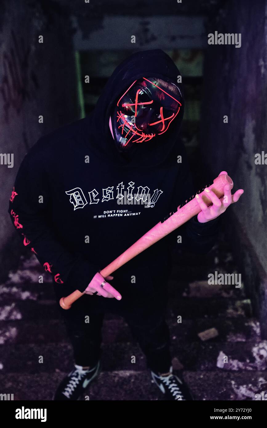 A creepy masked character of the purge anarchy with a baseball bat ...