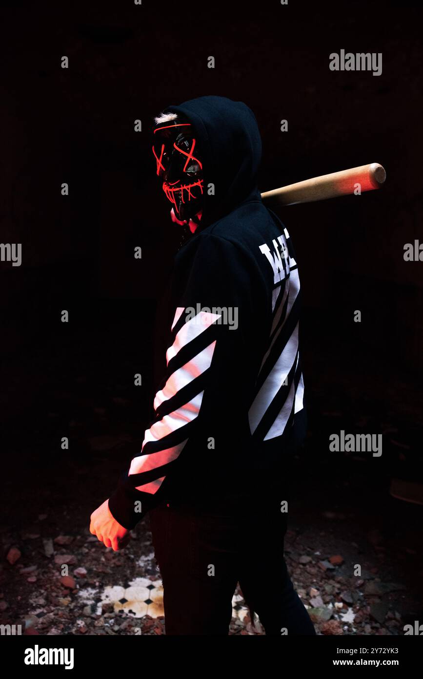 A creepy masked character of the purge anarchy with a baseball bat ...