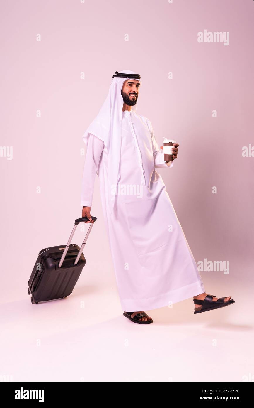 Arab businessman wearing emirati kandura portrait in studio in Dubai ...