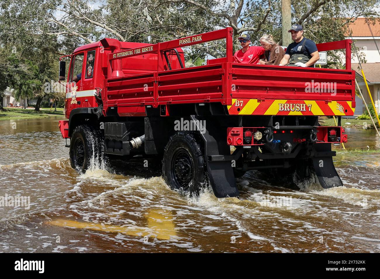 Members of the St. Petersburg Fire Rescue help a resident from the ...