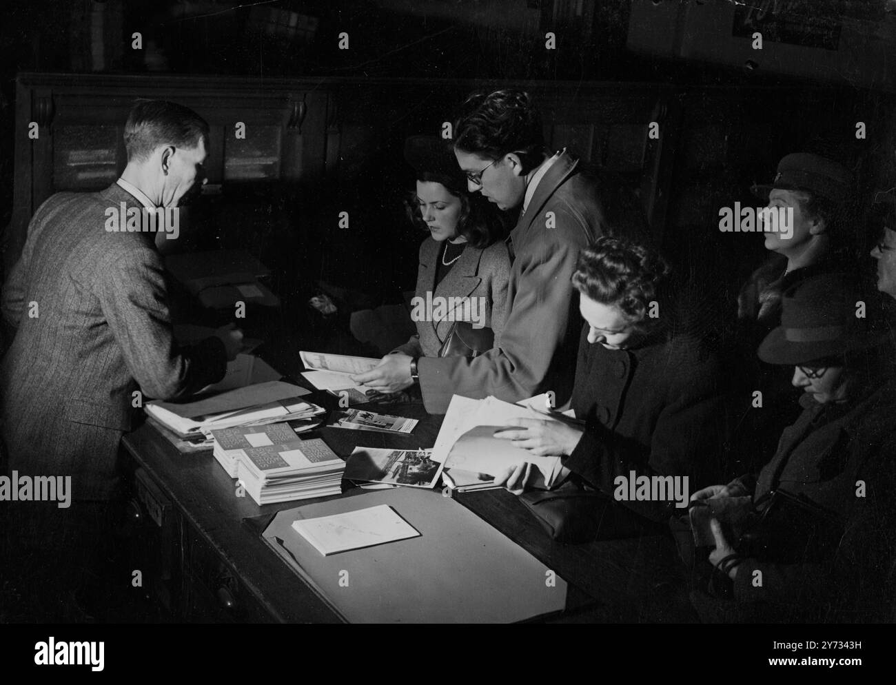 Customers looking through catalogues with agents at Thomas Cook 's ...