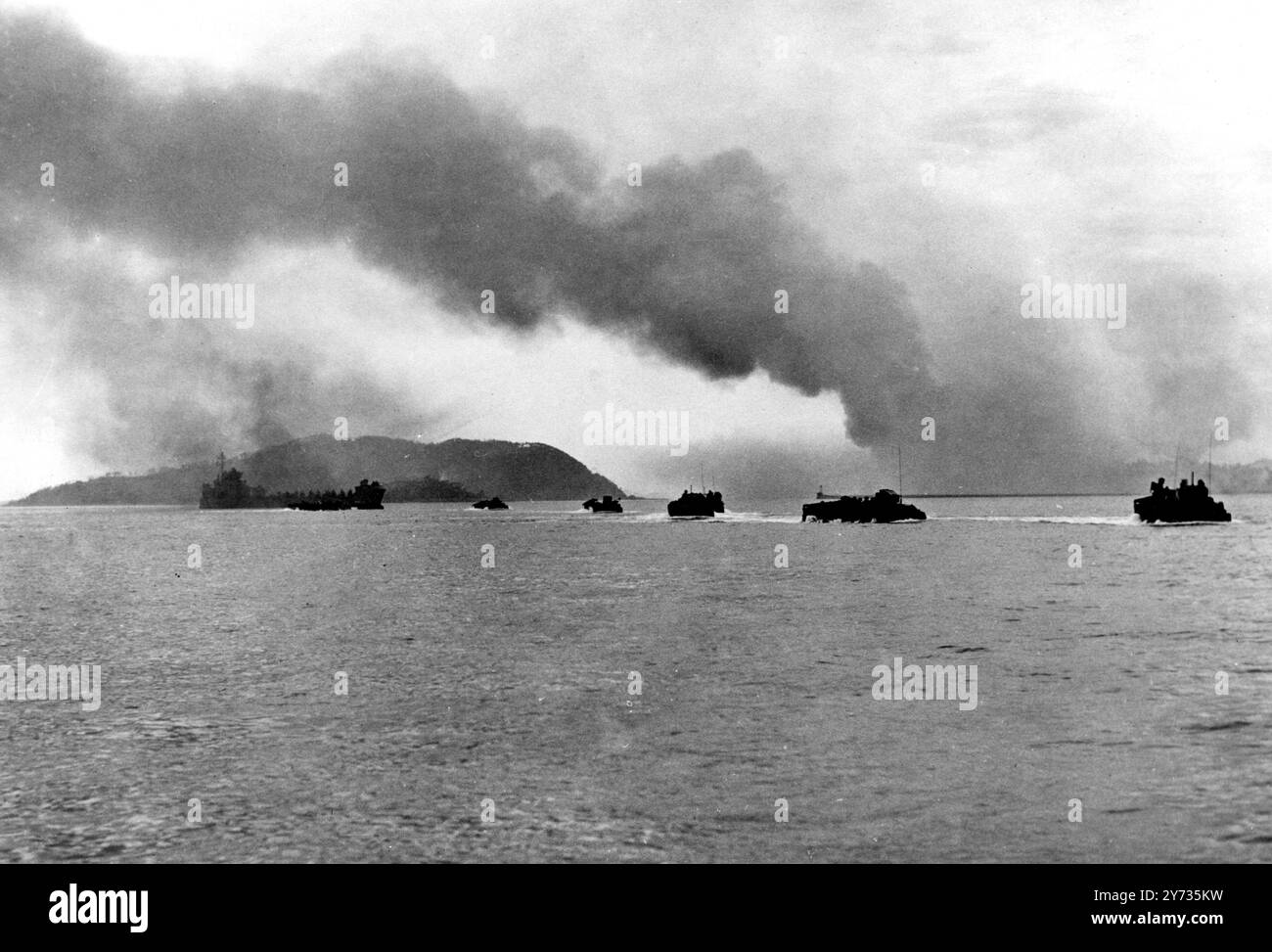 Line of small troop carrying vessels move speedily toward Wolmi island ...