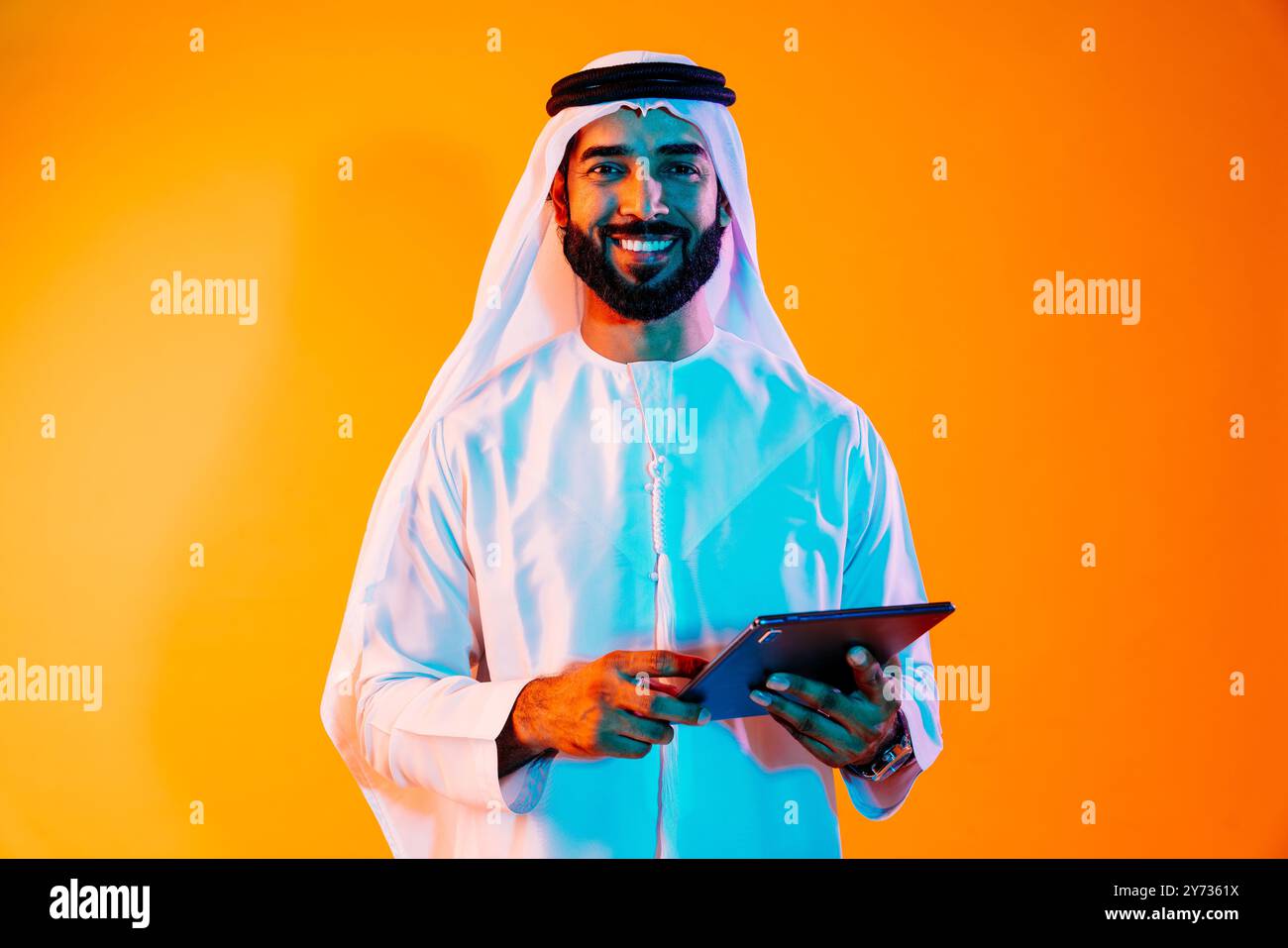 Arab businessman wearing emirati kandura portrait in studio in Dubai ...