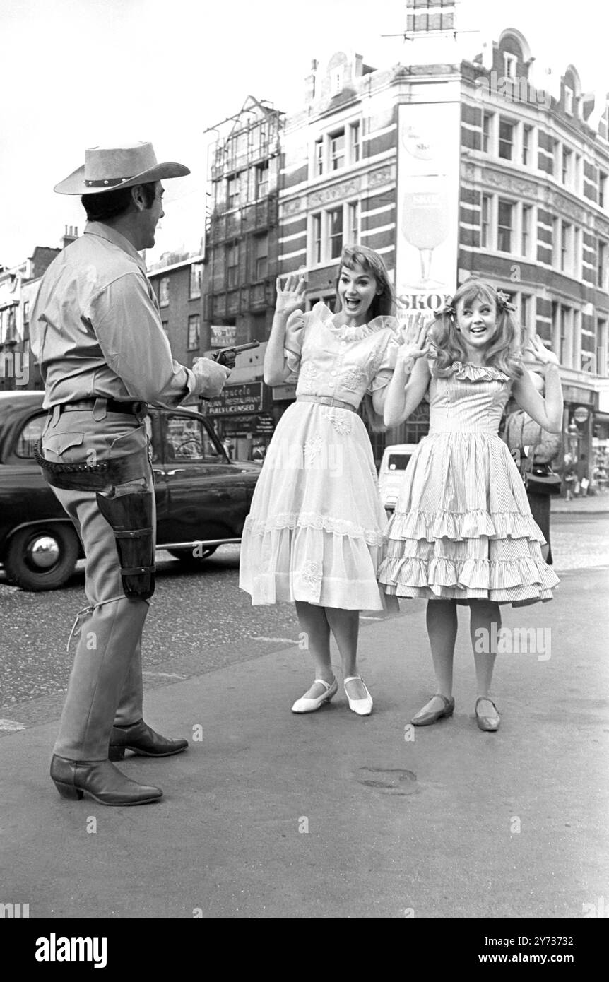 Singer Ivor Emmanuel during a mock hold-up of actresses Inga Swenson ...