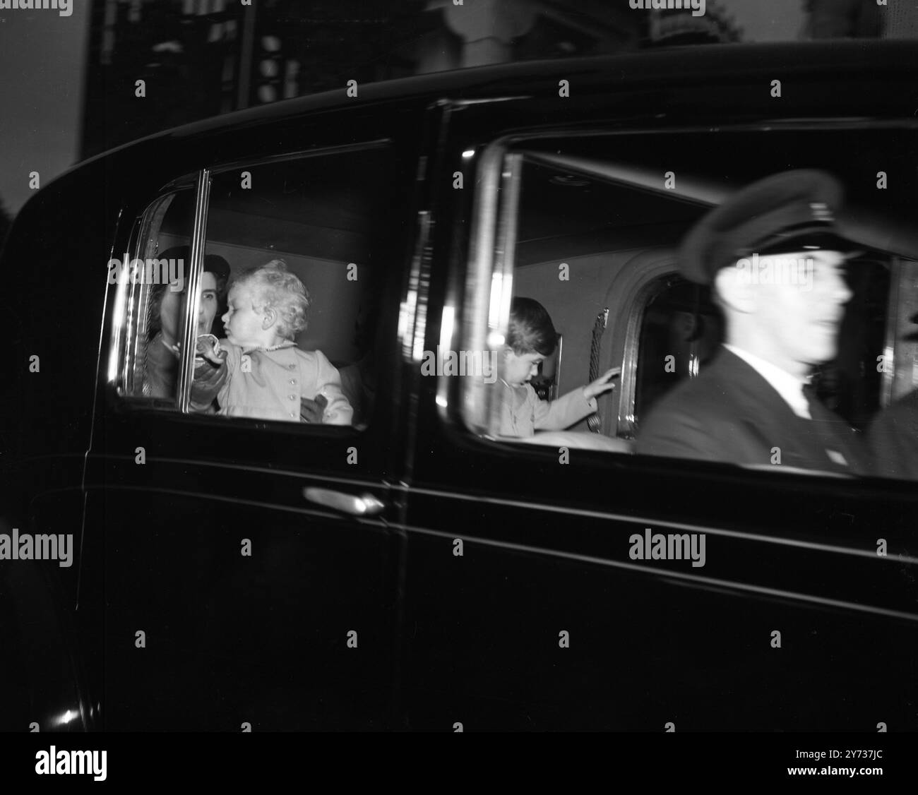 Nurse Helen Lightbody holds Princess Anne , and Prince Charles amuses ...