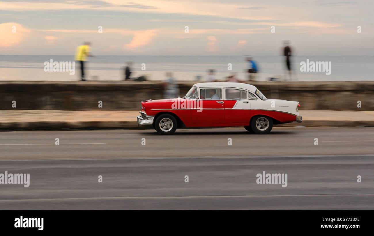 743 Old white and red American classic car -Chevrolet 1956- driving on ...