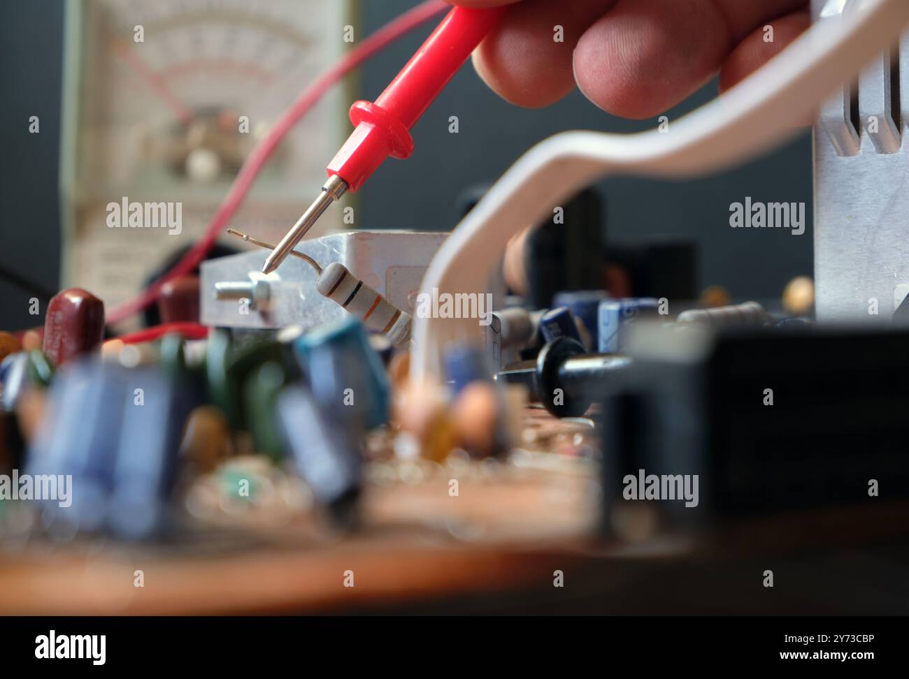 Technician is troubleshooting on the electronic circuit board. Testing ...