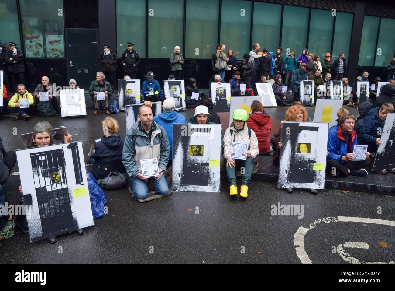 London, UK. 27th Sep, 2024. Protesters holding pictures of numerous ...