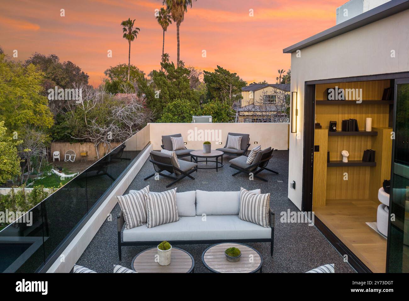 Modern rooftop terrace with stylish outdoor furniture and sunset view ...