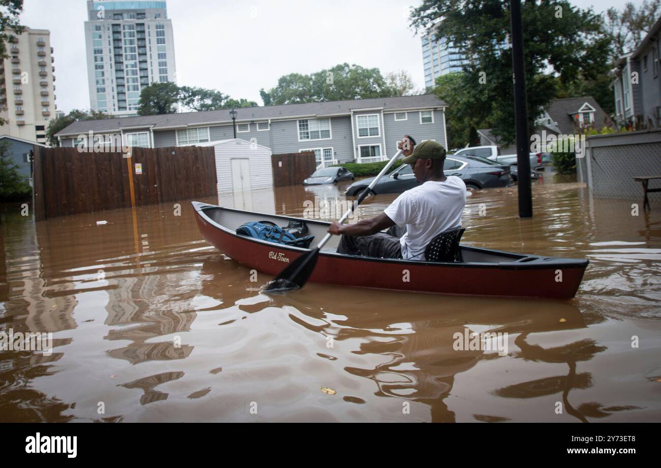 An unidentified man paddles a canoe to rescue residents and their ...