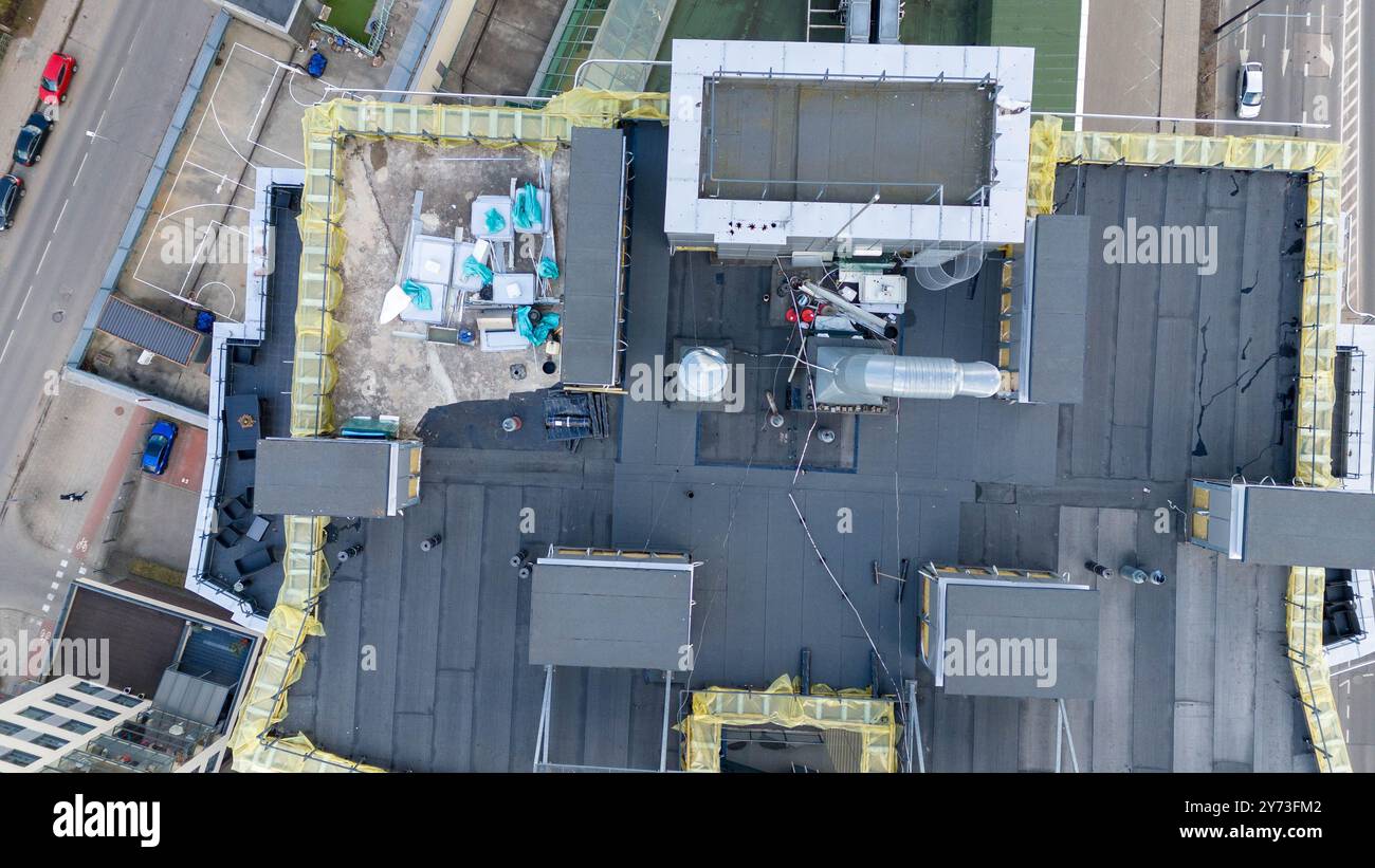 Aerial view of a rooftop with various structures. The surrounding ...