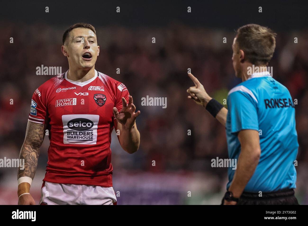 Deon Cross of Salford Red Devils reacts with the line official during ...