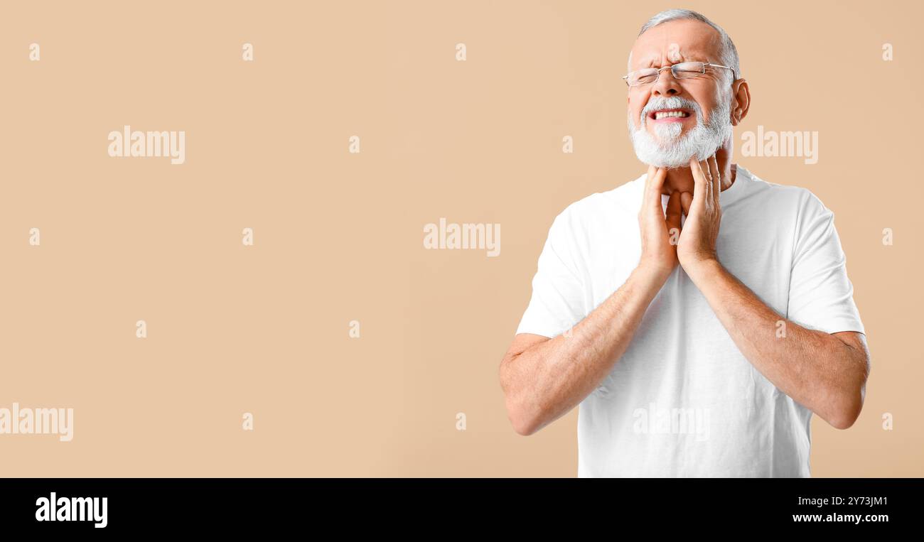 Ill old man with sore throat on beige background with space for text ...