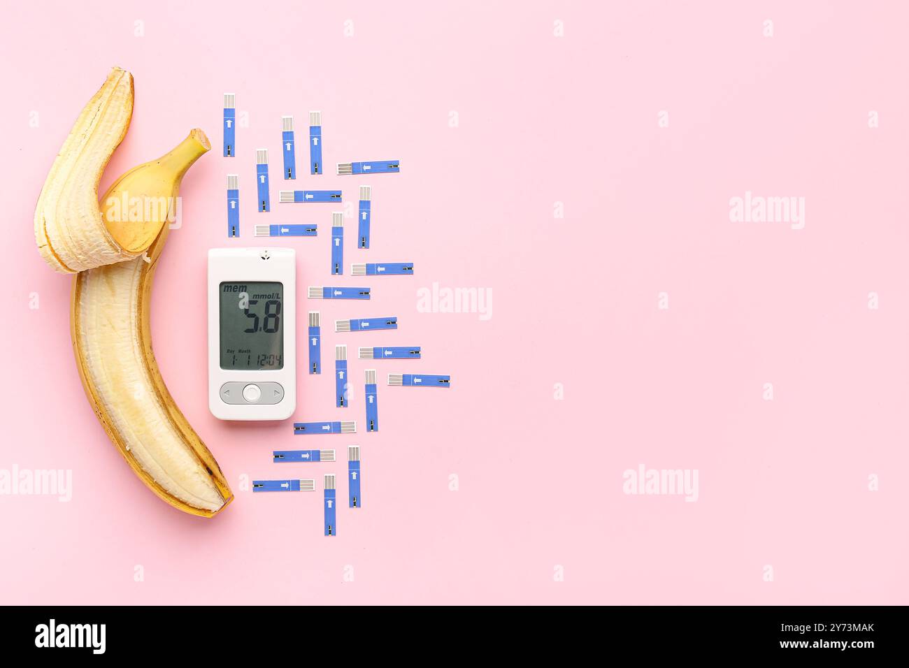 Composition with digital glucometer, ripe banana and scarificators on ...