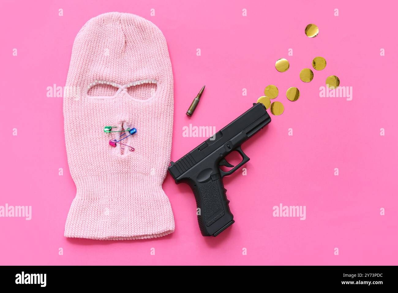 Composition with balaclava, gun and confetti on pink background Stock ...