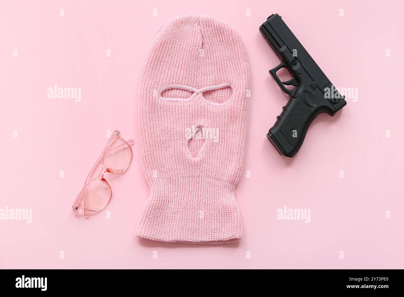 Balaclava, gun and sunglasses on pink background Stock Photo - Alamy
