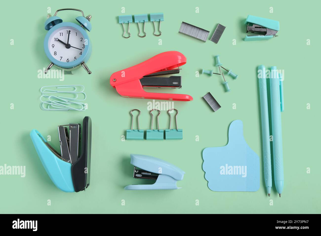 Different staplers with staples, clips, pens, sticky note in shape of ...